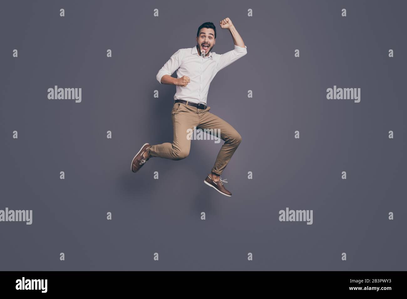 Full length photo of young handsome business man jumping high up ...