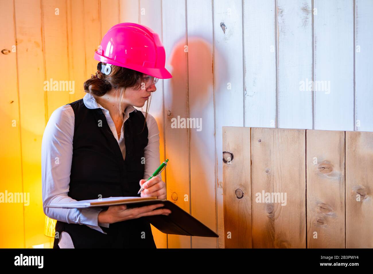 construction inspector woman wearing pink hard hat and protective ...