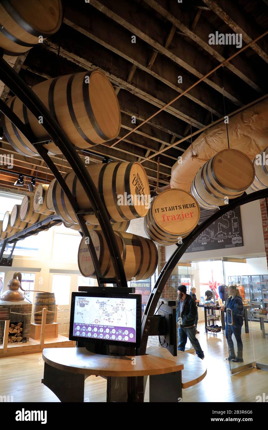 Visitors inside of Frazier History Museum with whiskey barrels.the starting point of Kentucky ...