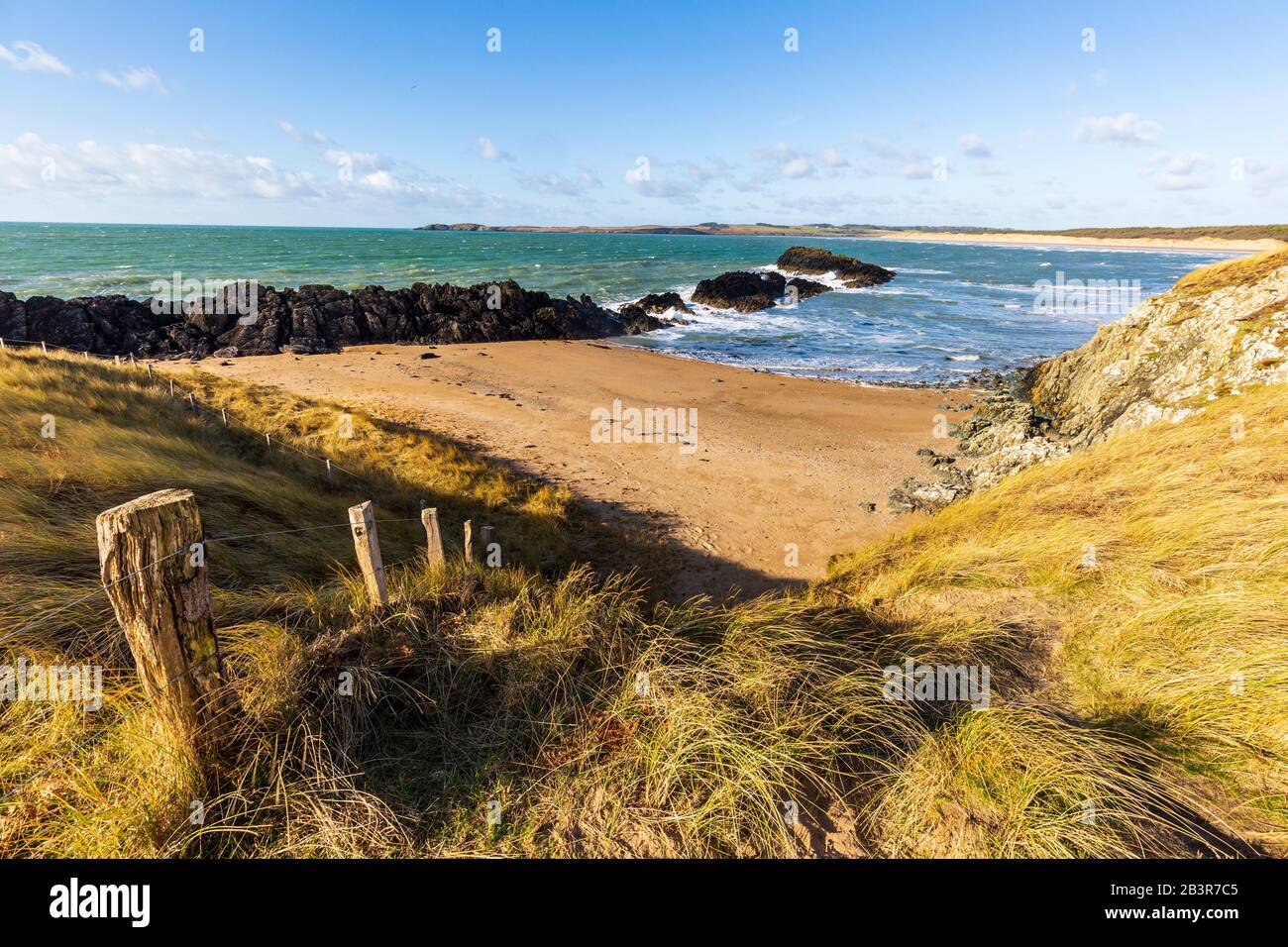 A small beach on Llanddwyn island looking towards Malltraeth beach ...