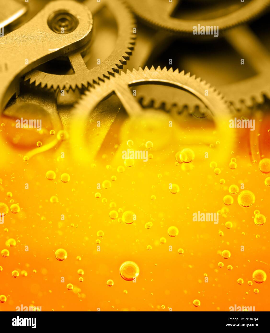 Metal gear in oil. Car service concept. Oil change in mechanisms ...