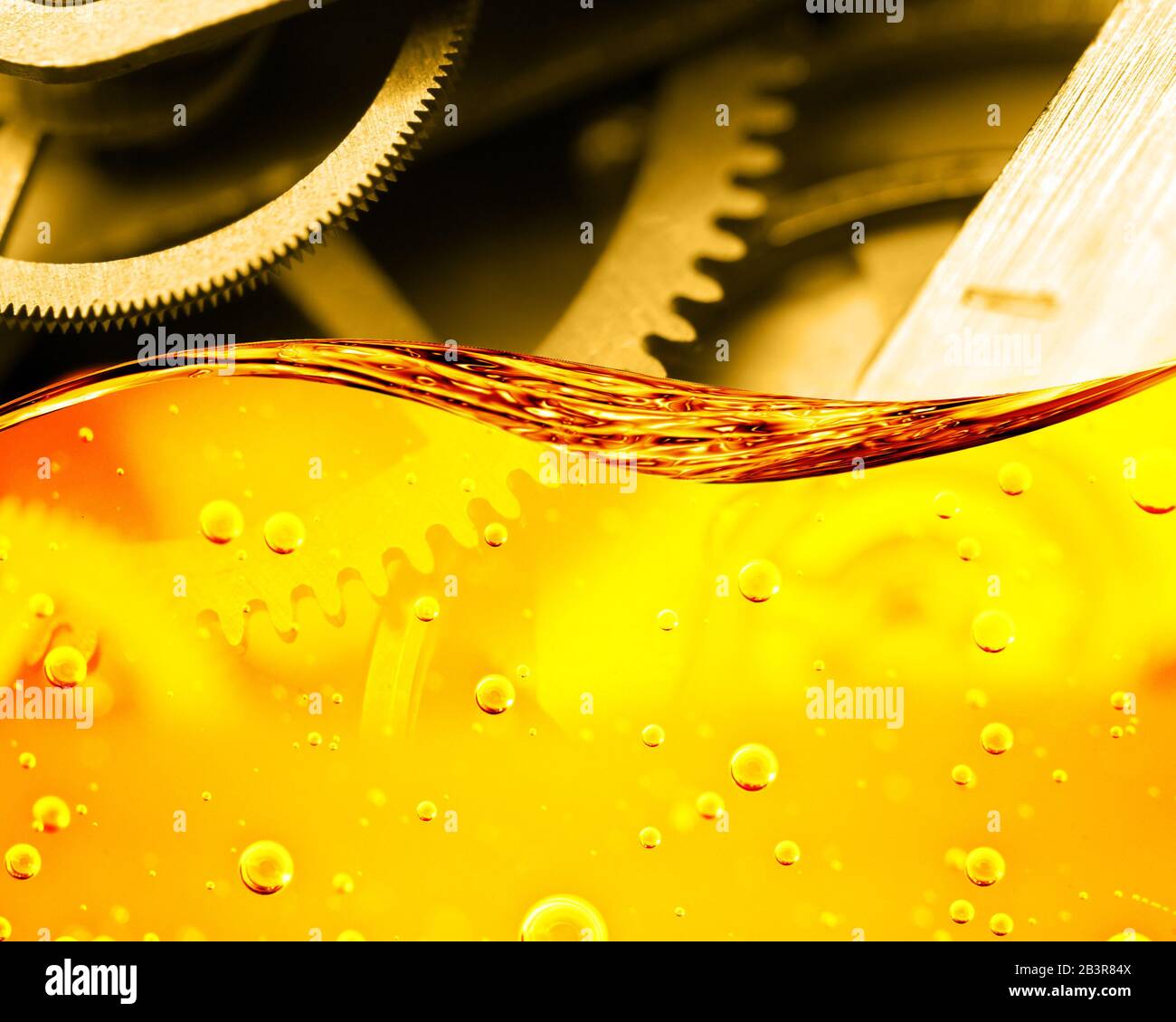 Metal gear in oil. Car service concept. Oil change in mechanisms ...