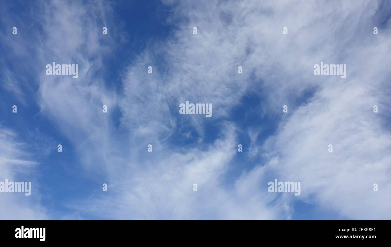 Fluffy white clouds and blue sky Stock Photo - Alamy