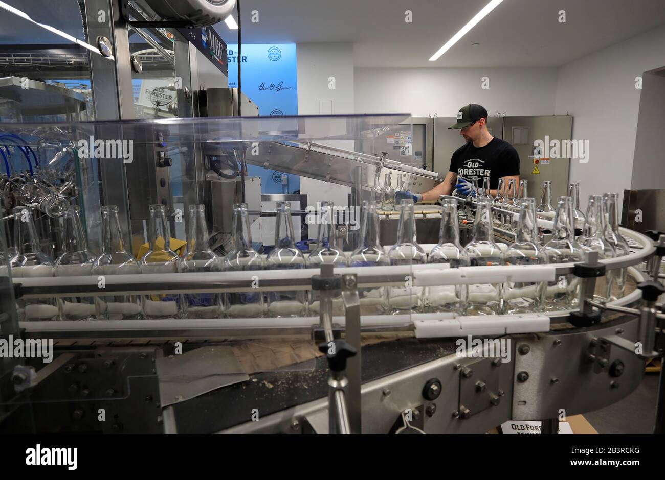 A man working on the bottling line of Bourbon whiskey in Old Forester ...
