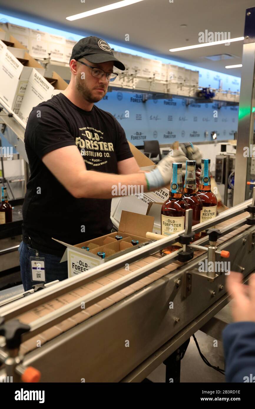 A man working on the bottling line of Bourbon whiskey in Old Forester ...