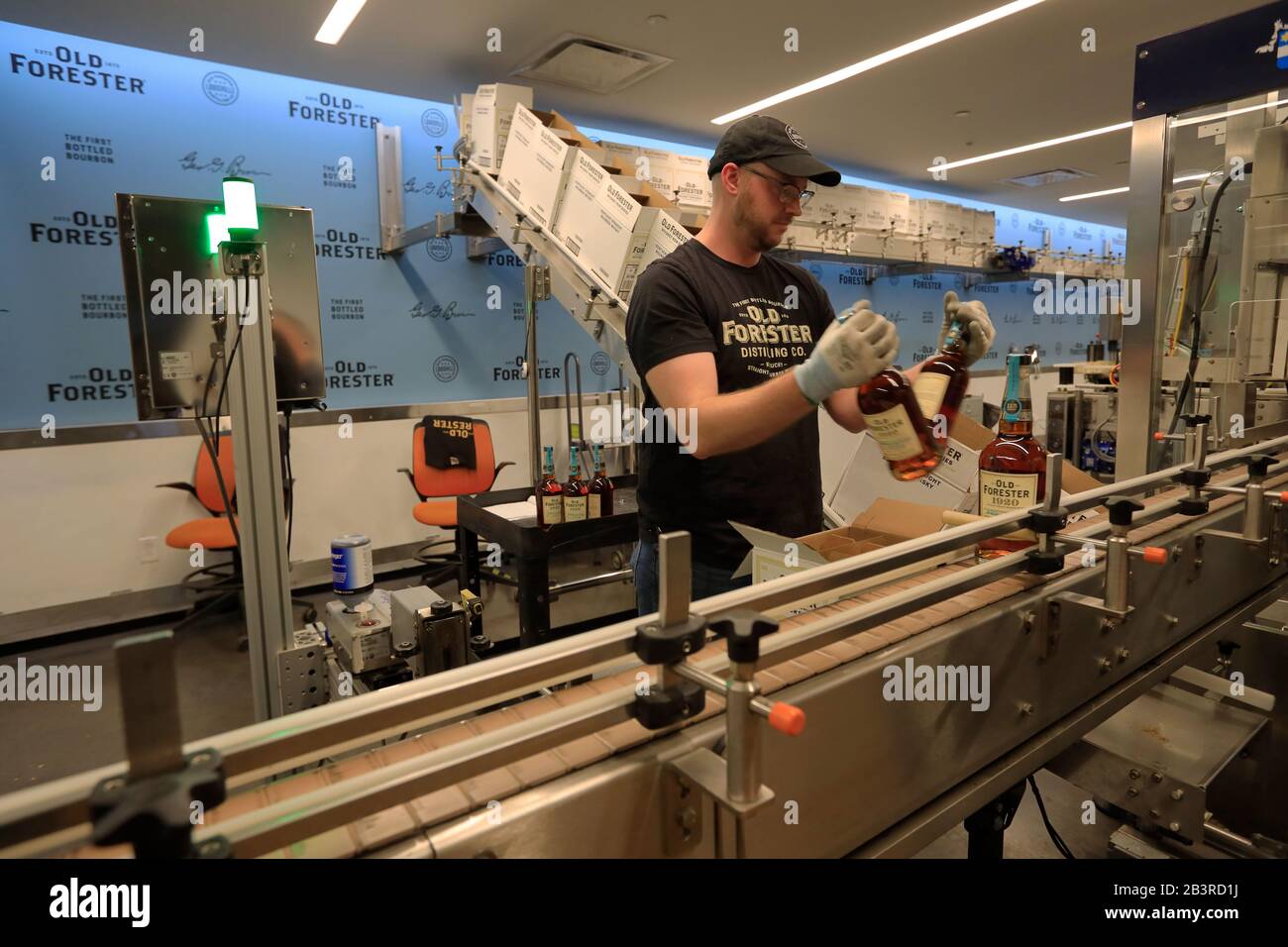 A man working on the bottling line of Bourbon whiskey in Old Forester ...