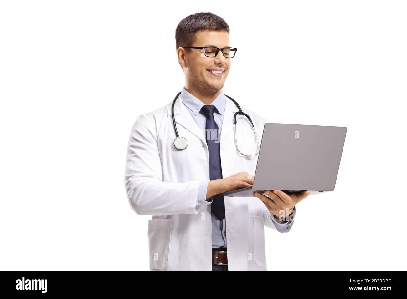 Doctor standing and using a laptop computer isolated on white ...