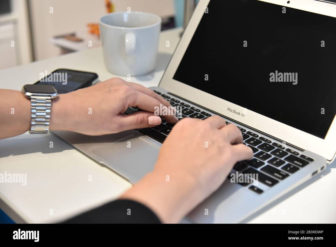 Overhead shot of womans hands working on apple laptop Stock Photo - Alamy