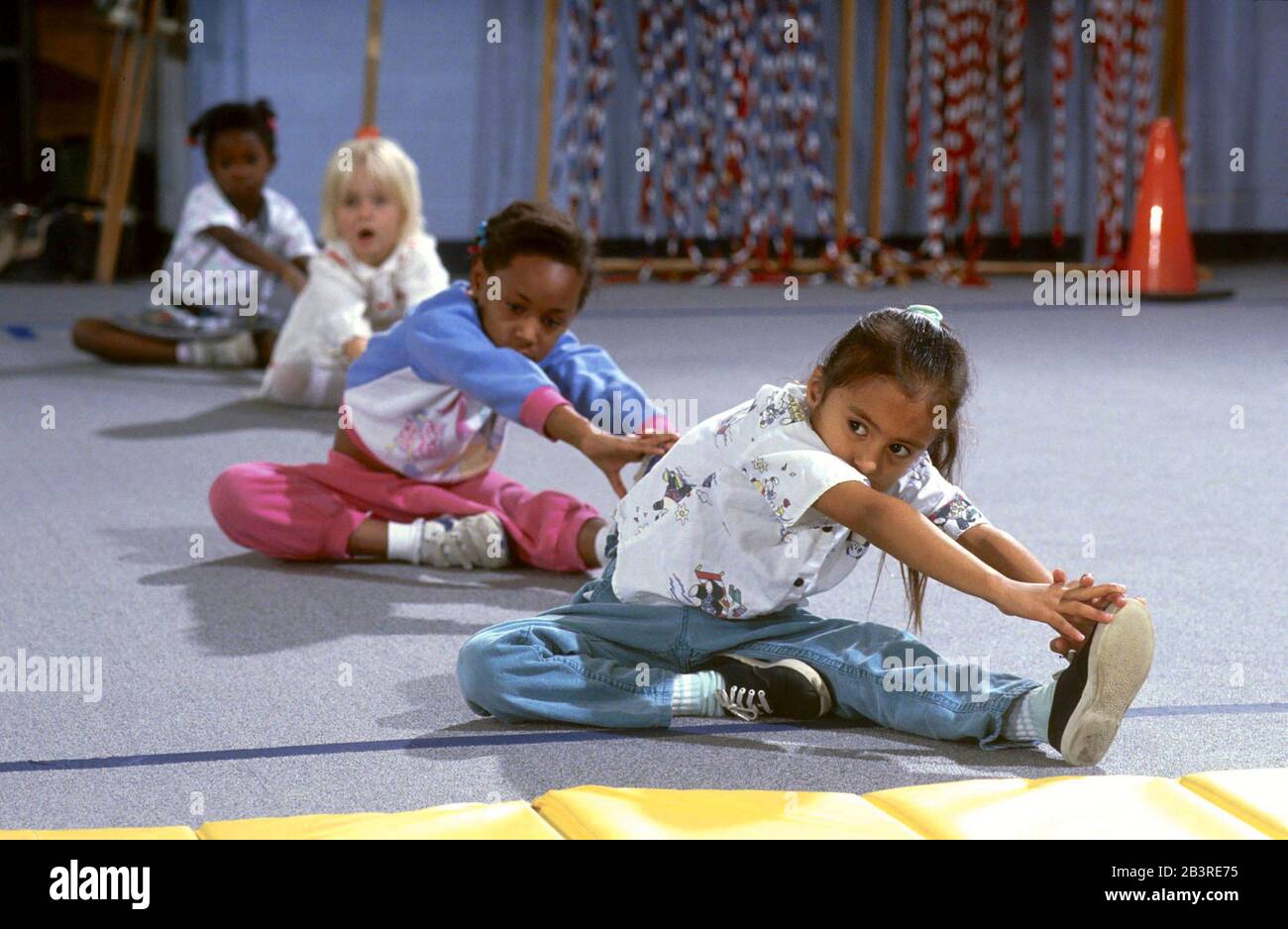 Austin Texas USA: Kindergarten students stretchtheir arms during ...