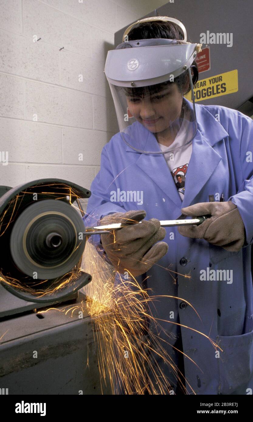 Austin Texas USA: Hispanic teenage girl using grinder with safety ...