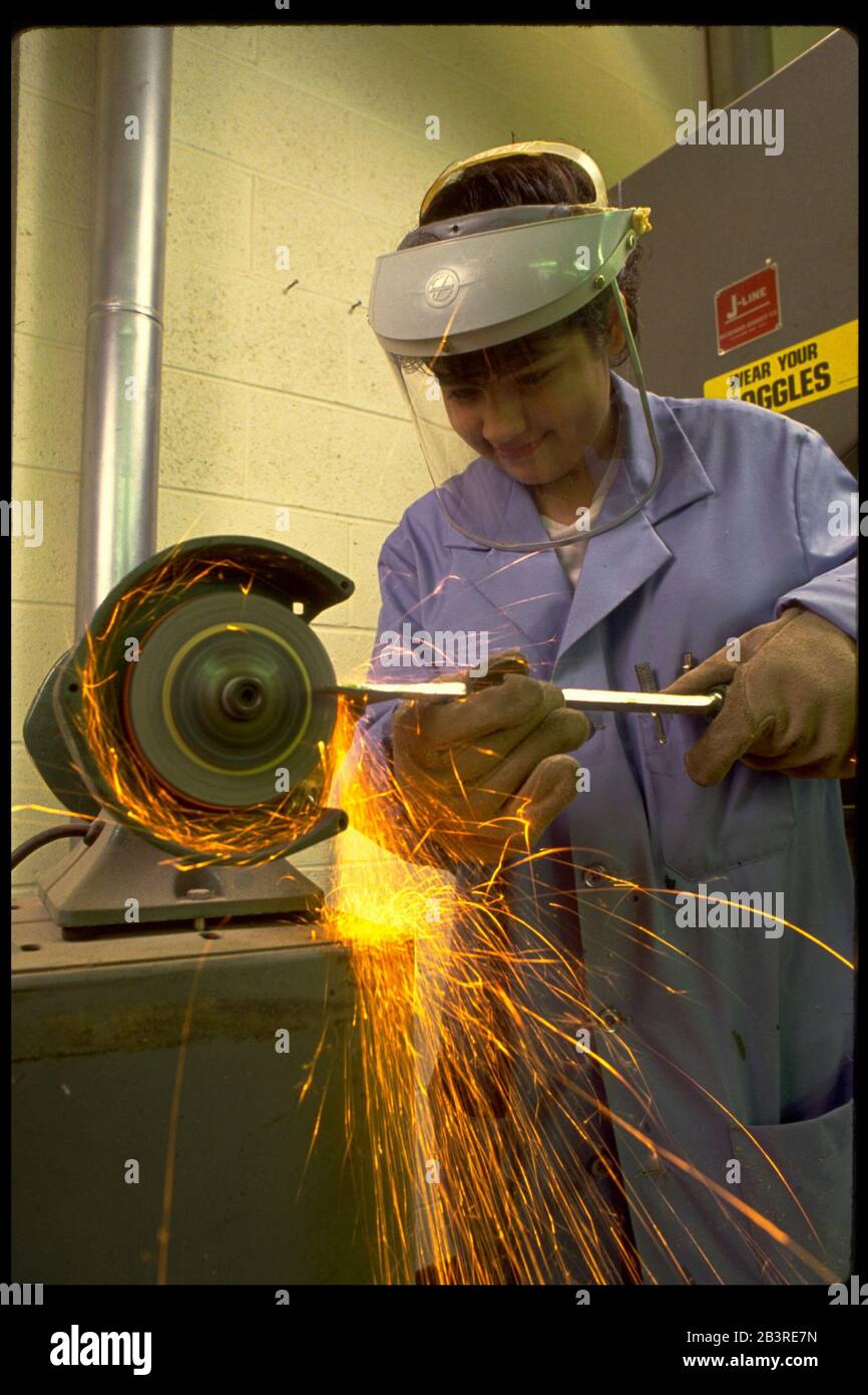 Austin Texas USA: Hispanic teenage girl using grinder with safety ...