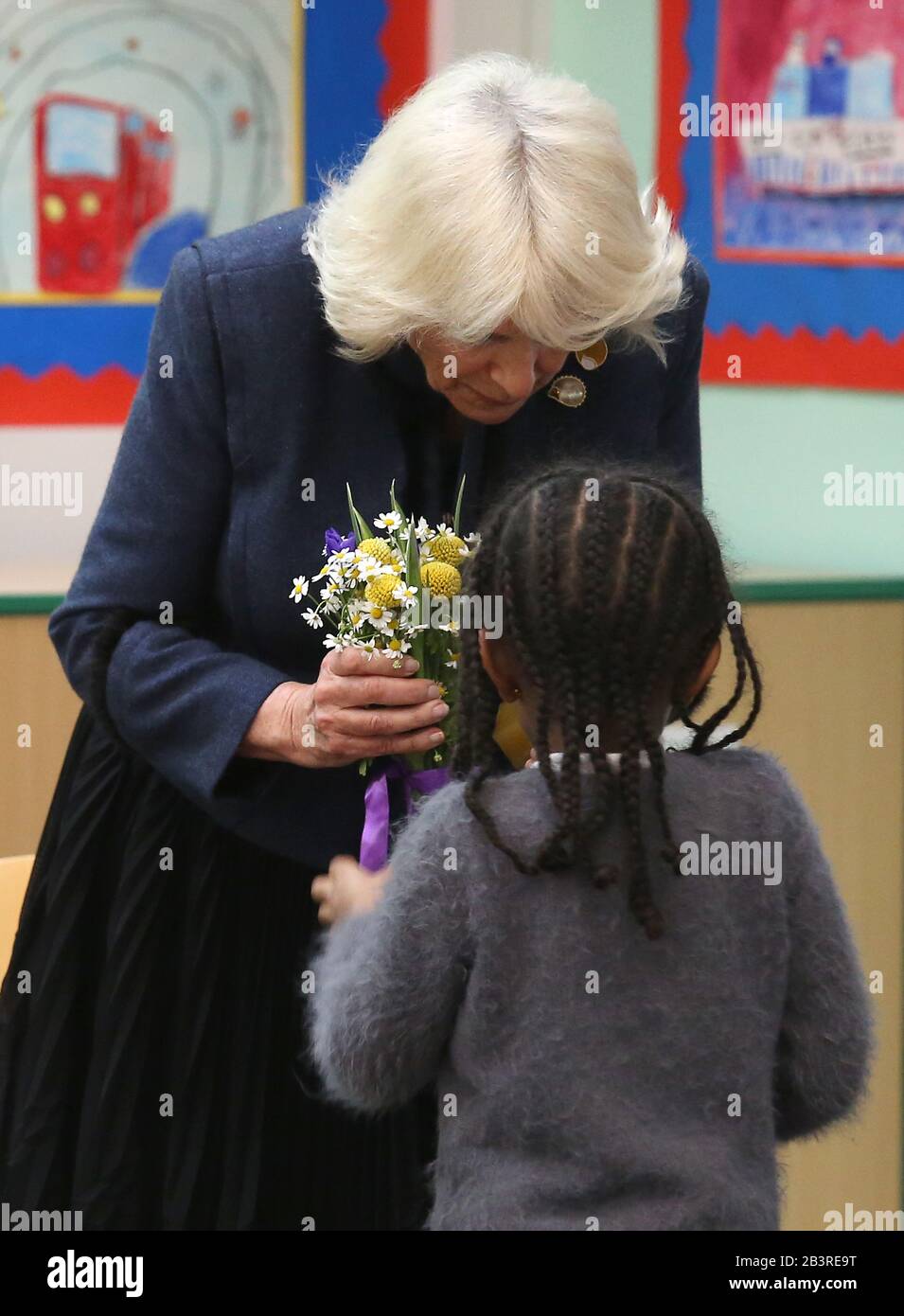The Duchess of Cornwall receives flowers during a visit to Bousfield ...