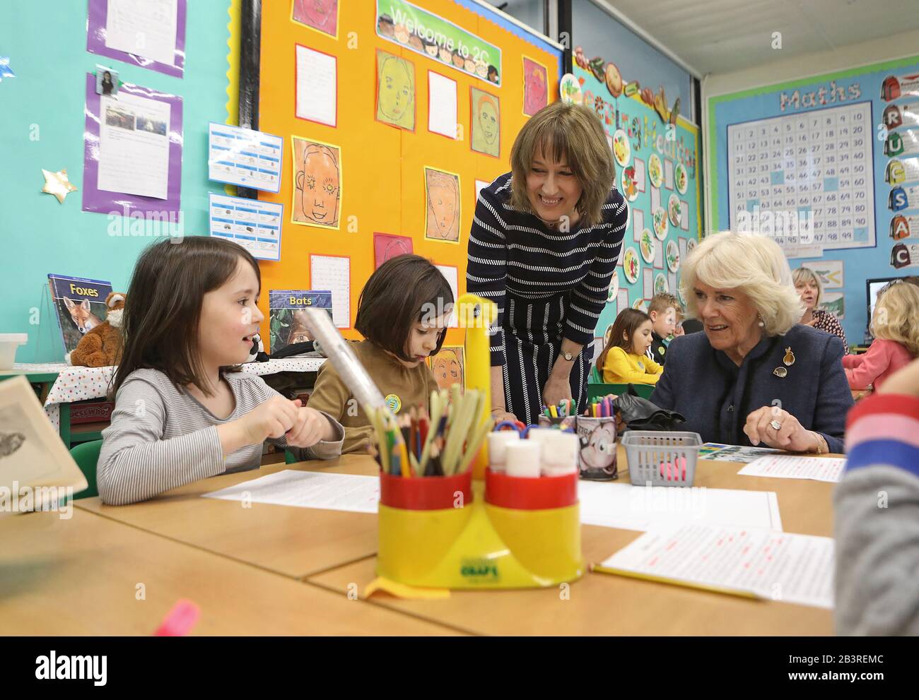 The Duchess of Cornwall (right), with headteacher Helen Swain, speaking ...