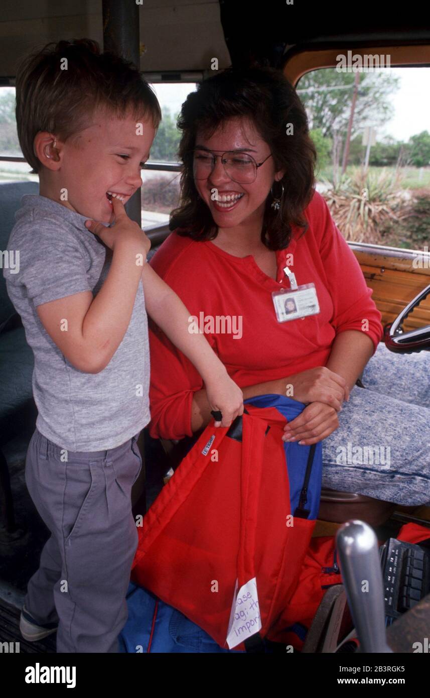 Austin Texas USA, March 1990: School bus driver Naka Hernandez with pre ...