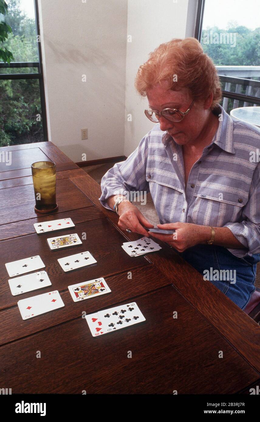Austin Texas USA, circa 1989: Woman playing solitaire on her dining ...
