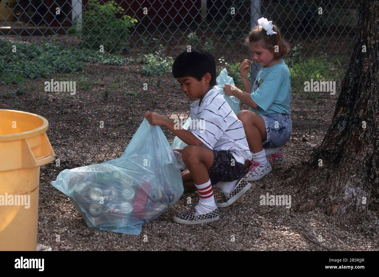 Austin Texas USA: Eight and nine year old boy and girl pick up litter ...