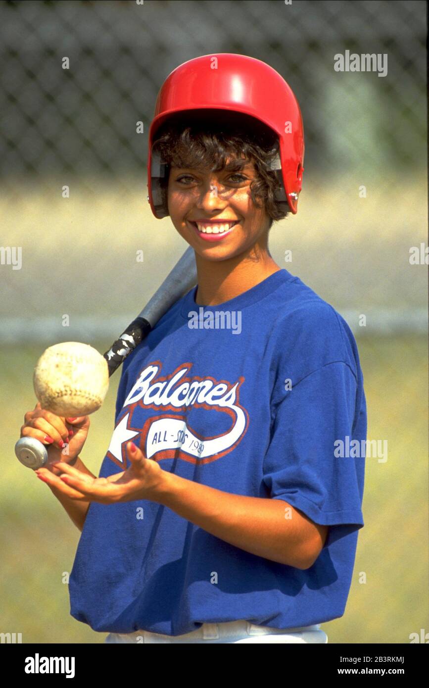Austin Texas USA, 1990: Hispanic teenage girl wearing batting helmet ...