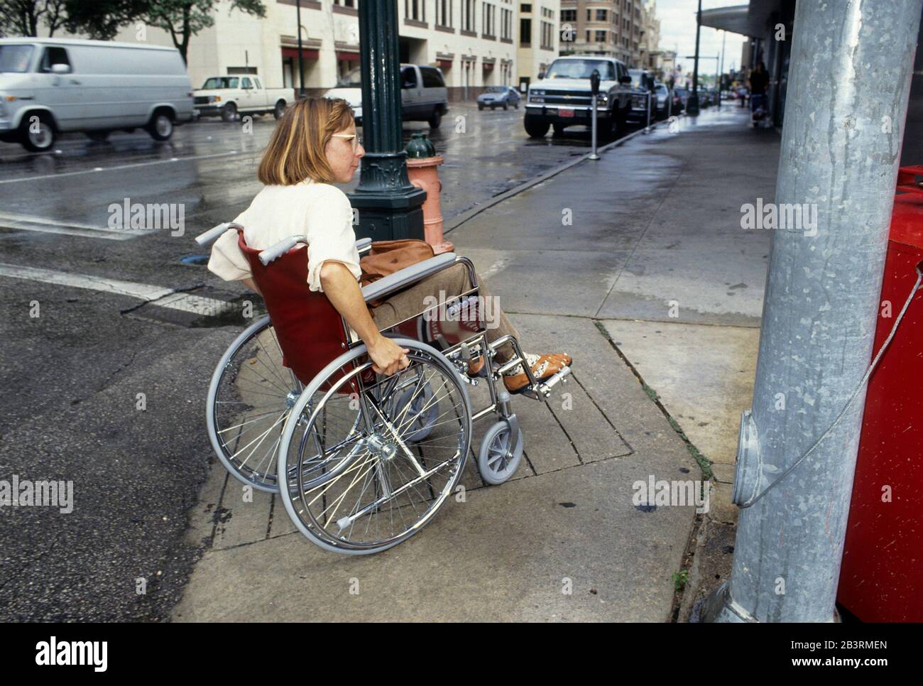 Austin, Texas USA: Handicapped woman in wheelchair uses curb cut and ...