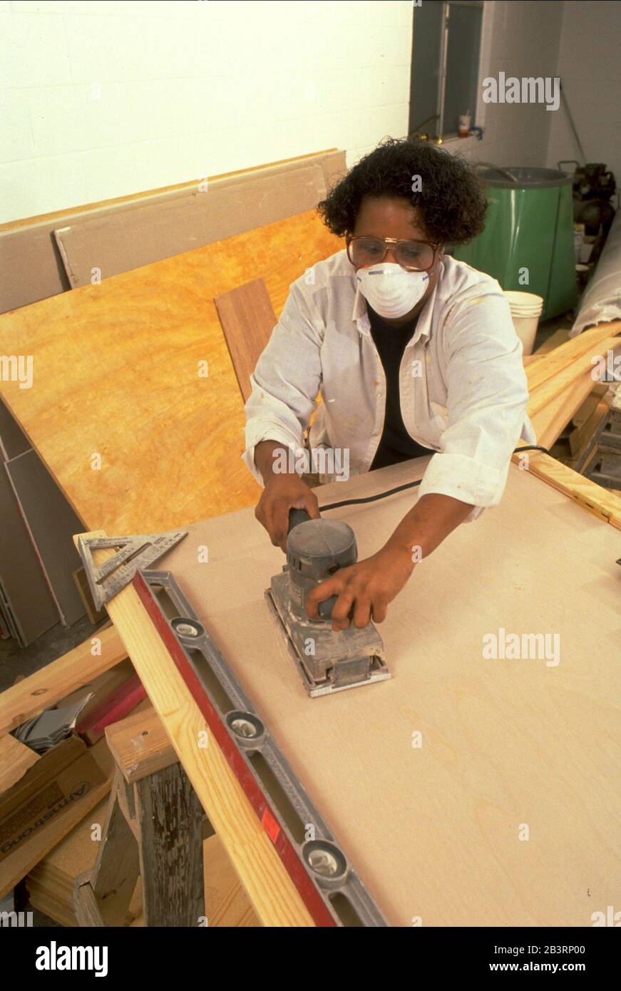 Black professional female carpenter at work on a door. MR ©Bob ...