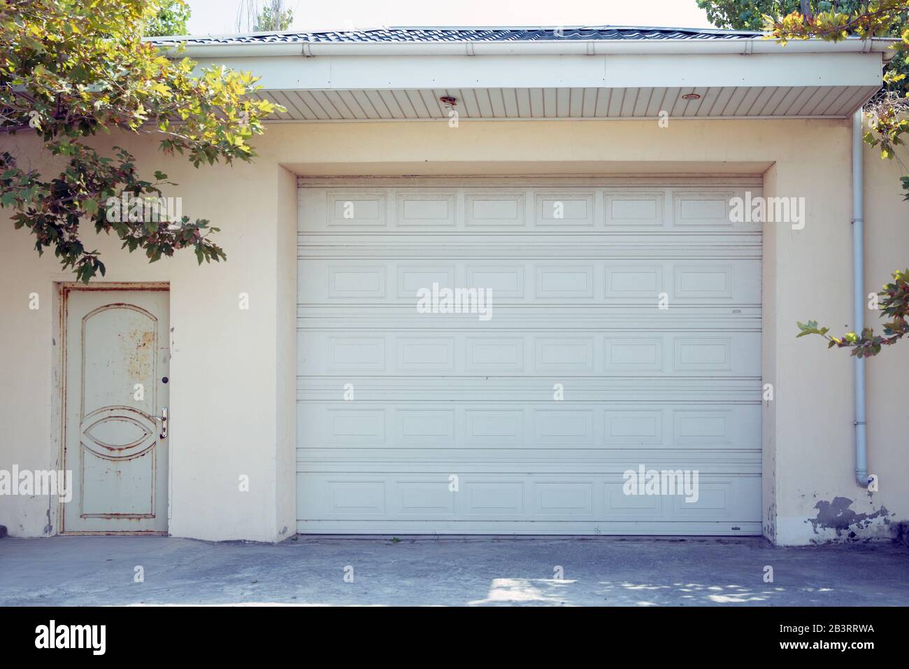 Shutter door or roller door and concrete floor outside .White Automatic shutters in a house ...