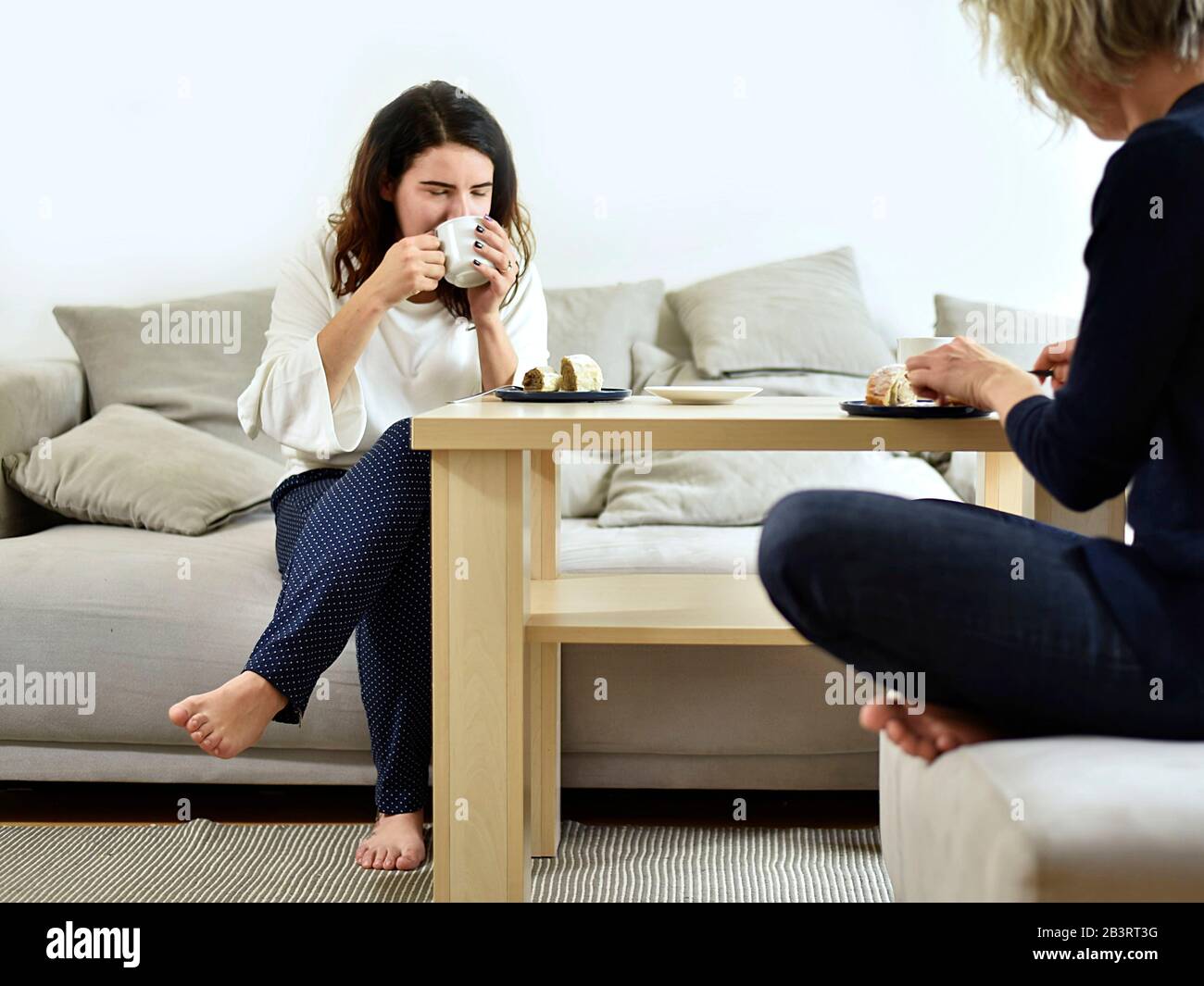 Two women sit hi-res stock photography and images - Alamy