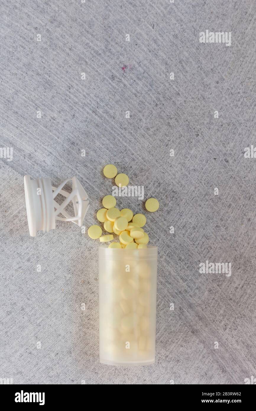 Yellow tablets on the marble. Vertical. Top view Stock Photo - Alamy