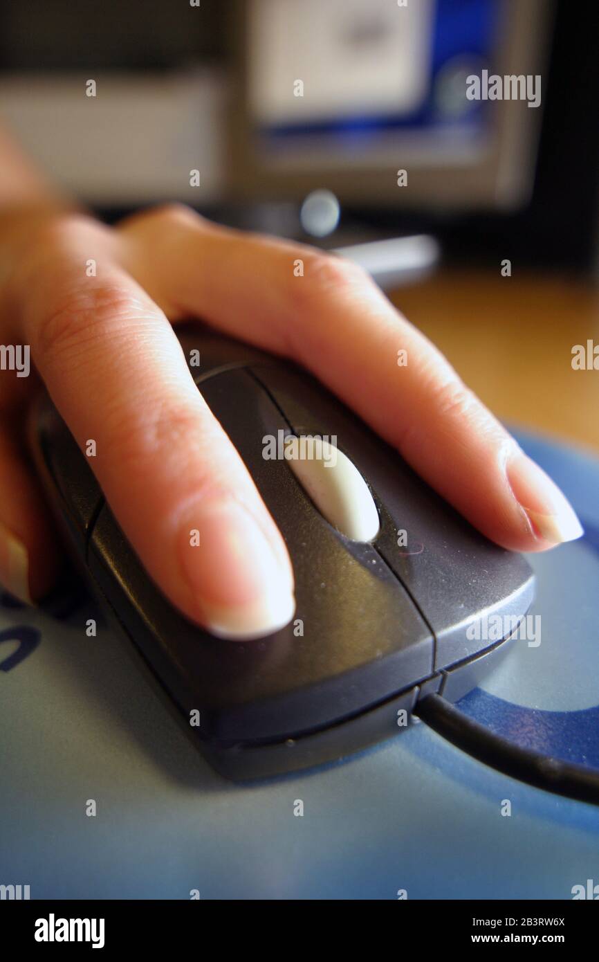 Woman using computer mouse UK Stock Photo - Alamy