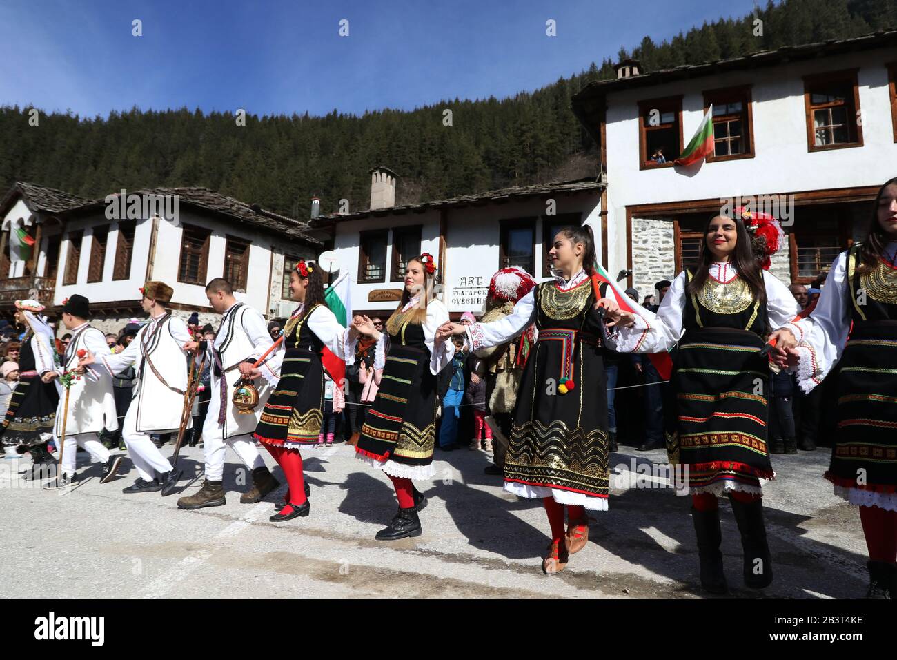 People in traditional costumes dance Bulgarian horo in Shiroka laka ...
