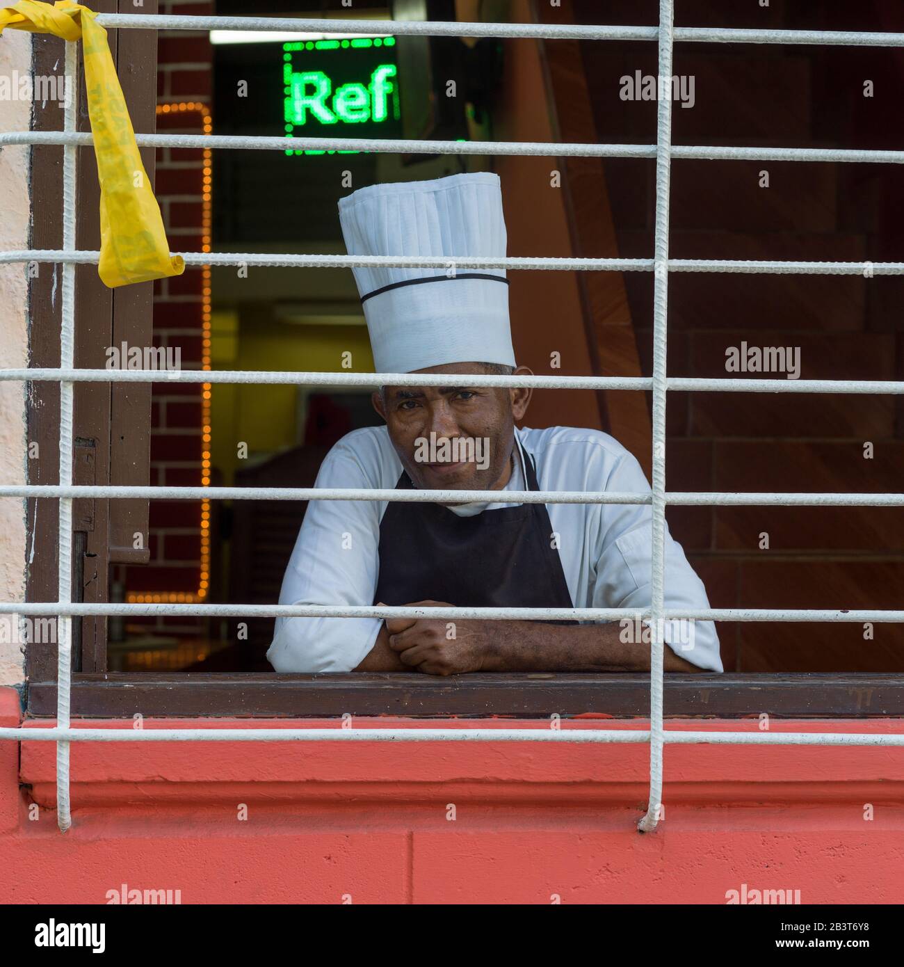 Portrait of male chef looking through window, Havana, Cuba Stock Photo ...