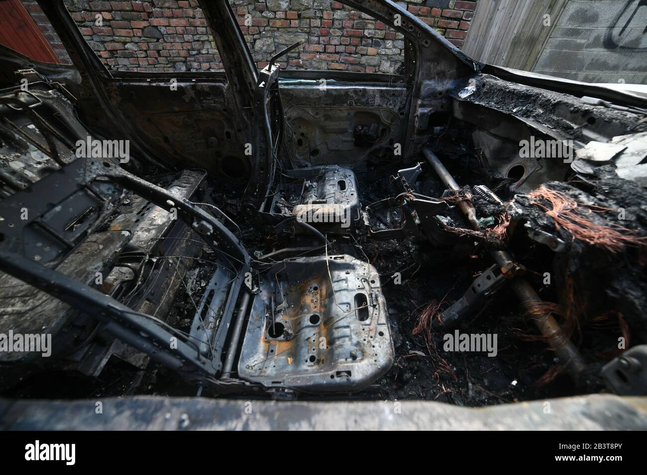 The remains of the Ford which was set alight showing a black burnt ...