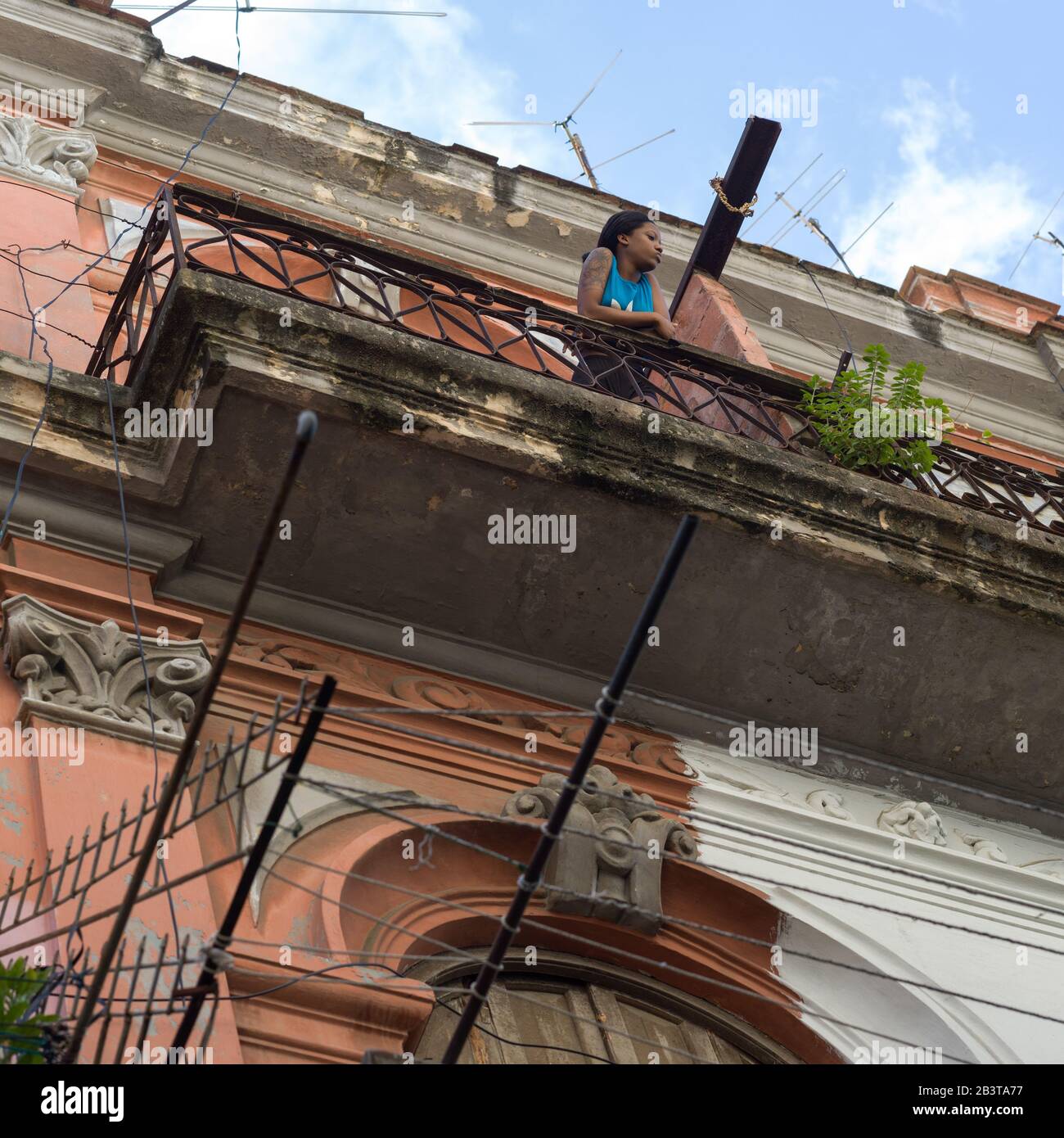Woman looking down from balcony hi-res stock photography and images - Alamy