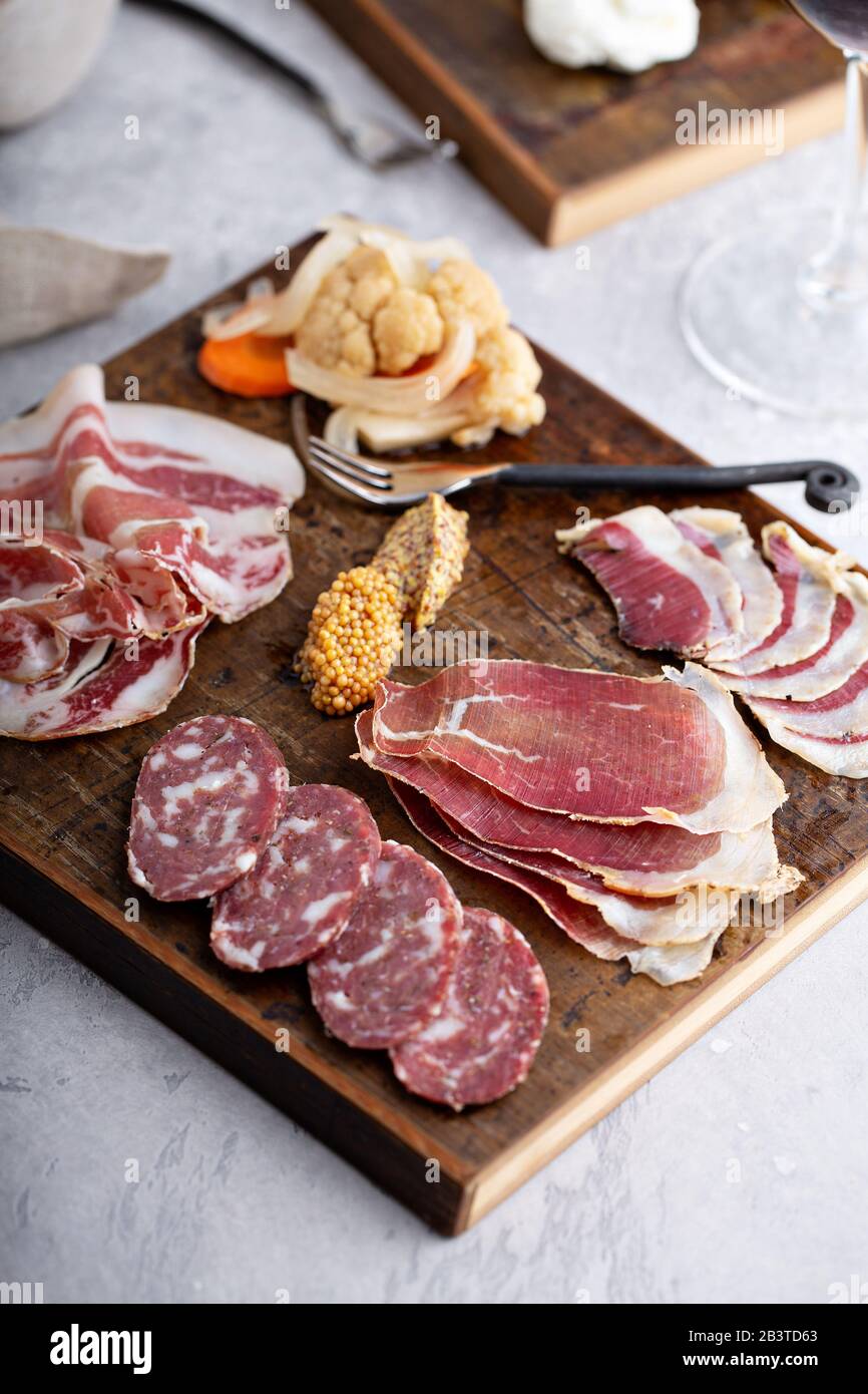 Meat charcuterie board with pickled vegetables and mustard Stock Photo ...
