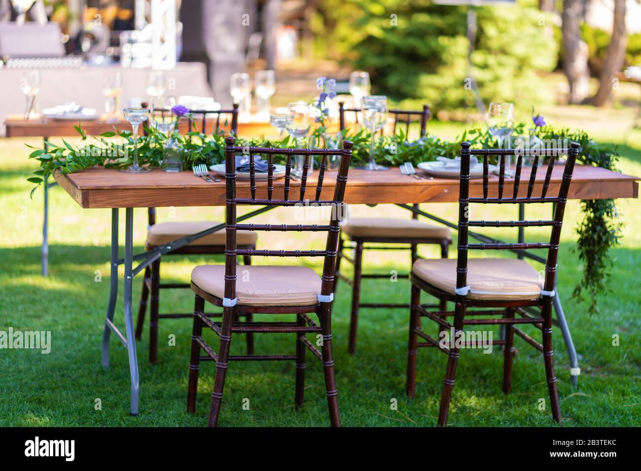 Preparing for an open-air party. Decorated served tables await guests ...