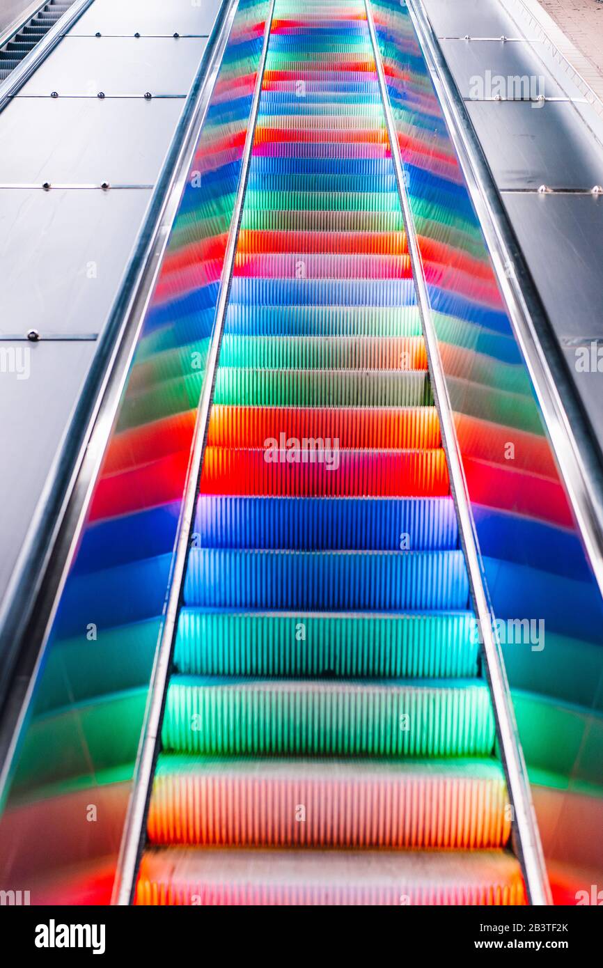 Escalator with multi-colored LED rainbow lights. Subway station in ...
