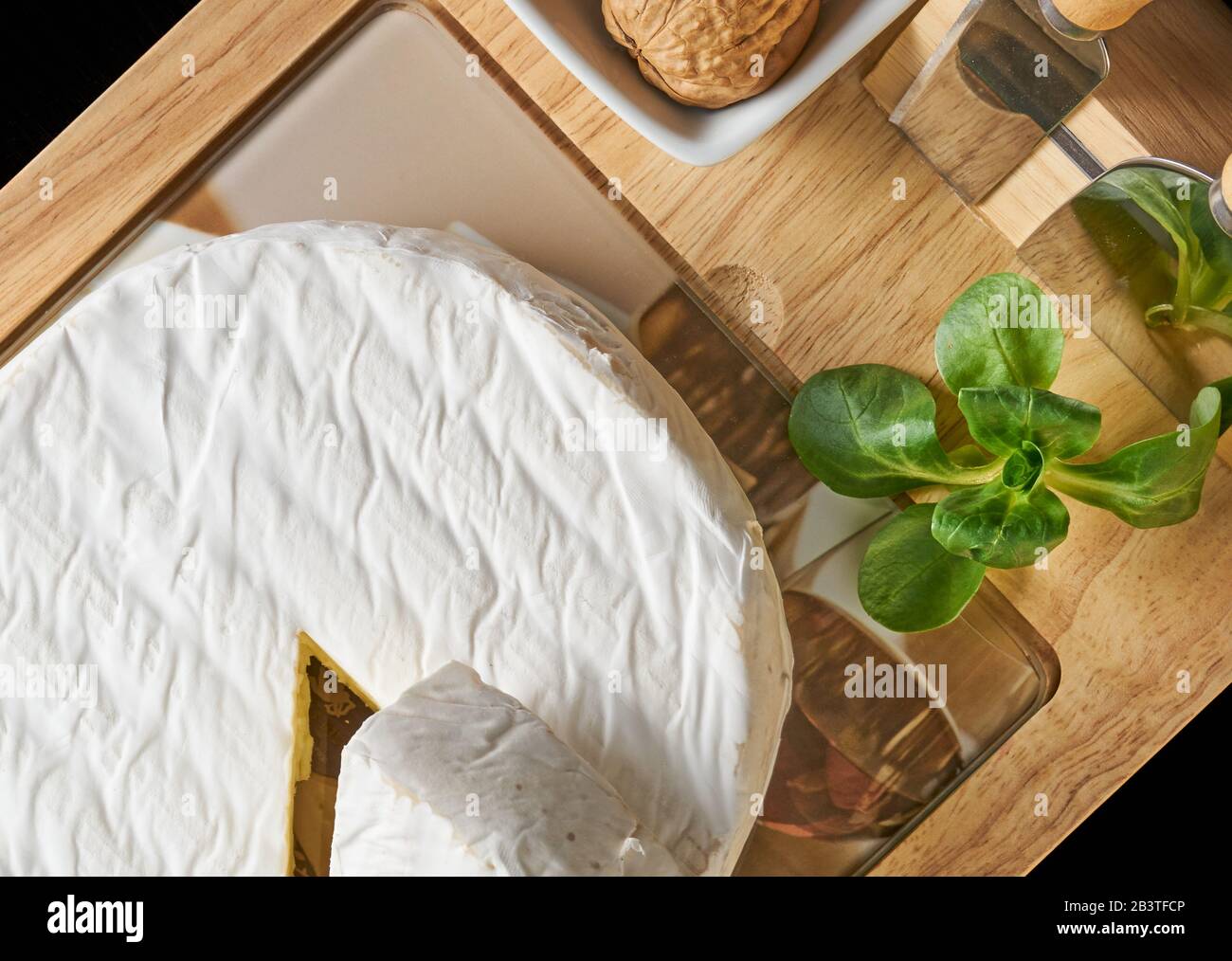 Round soft cheese, with a section cut Stock Photo - Alamy