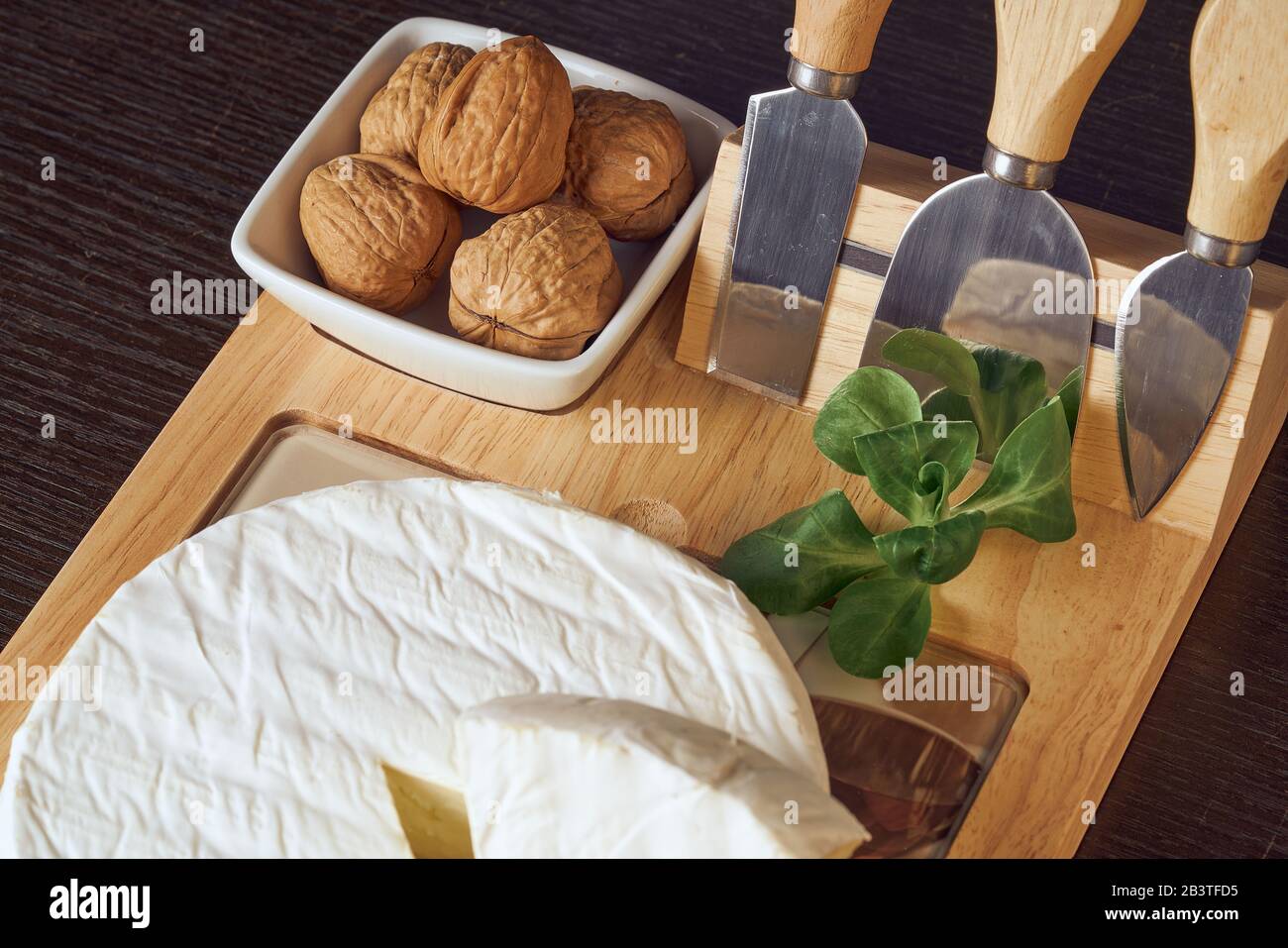 Round soft cheese, with a section cut Stock Photo - Alamy