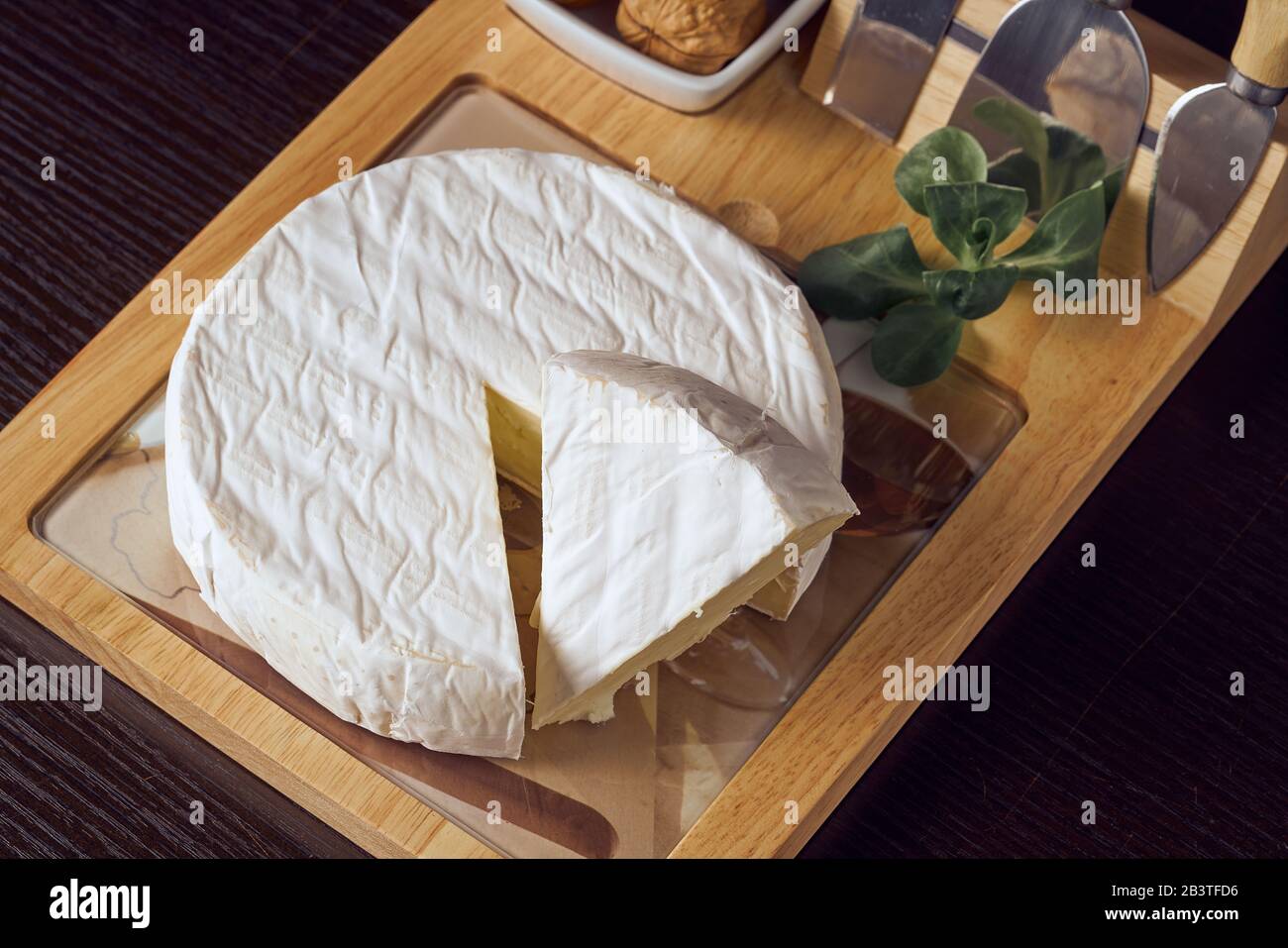 Round soft cheese, with a section cut Stock Photo - Alamy