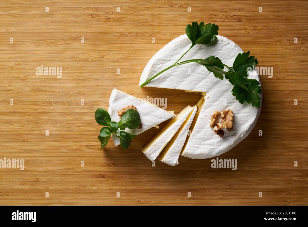Round soft cheese, with a section cut Stock Photo - Alamy