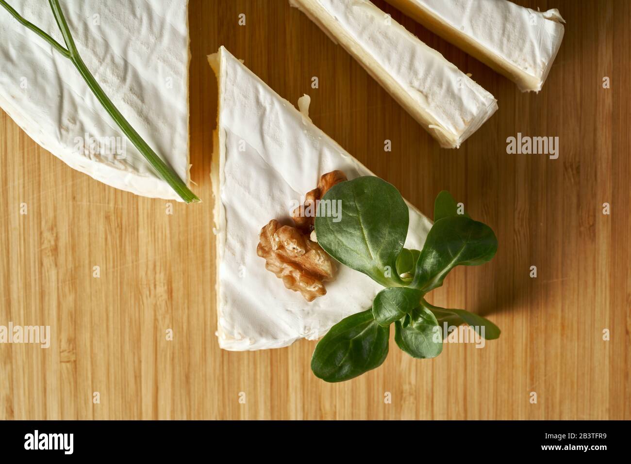 Round soft cheese, with a section cut Stock Photo - Alamy