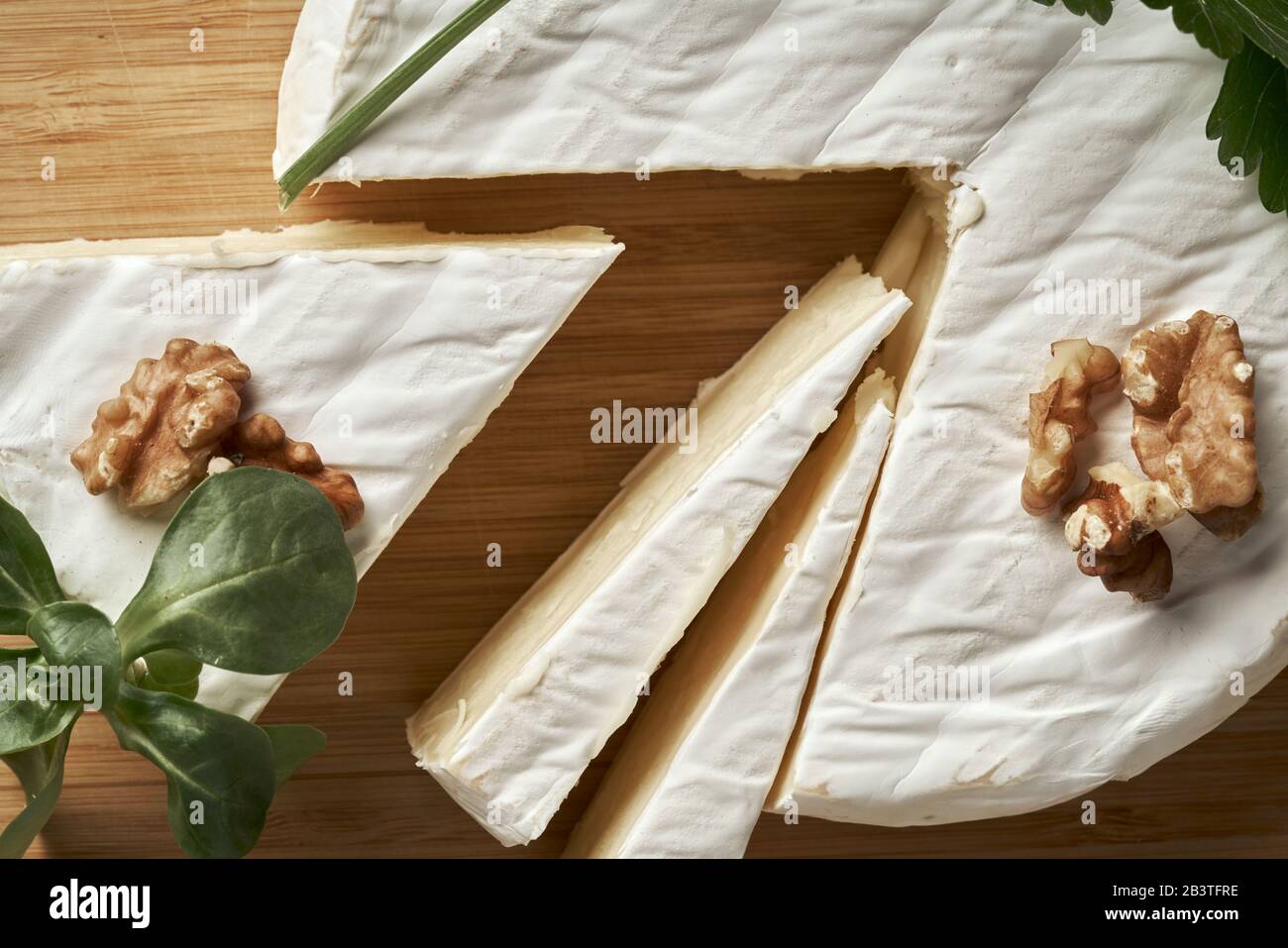 Round soft cheese, with a section cut Stock Photo - Alamy