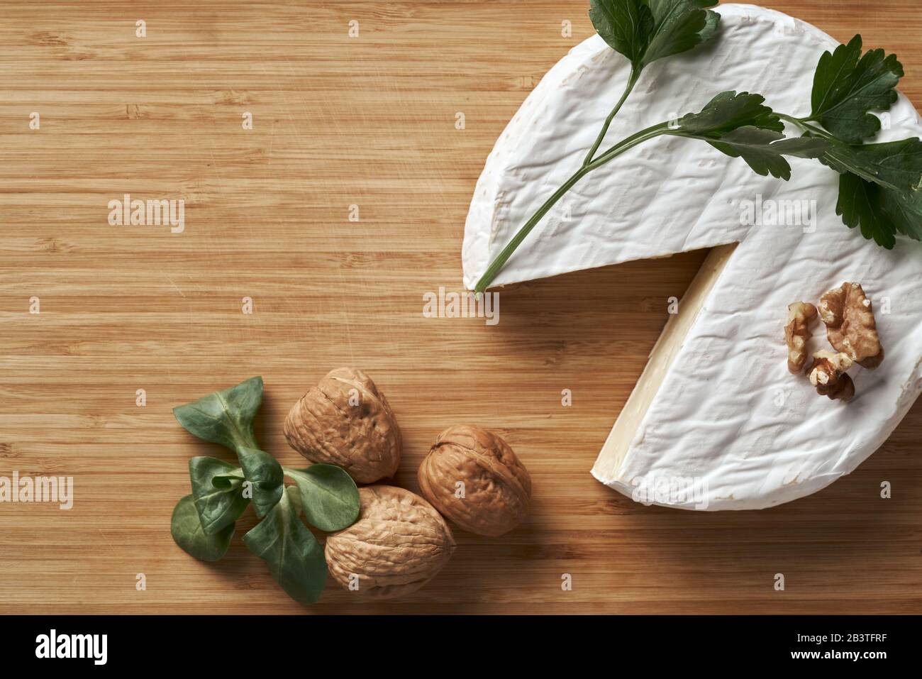 Round soft cheese, with a section cut Stock Photo - Alamy