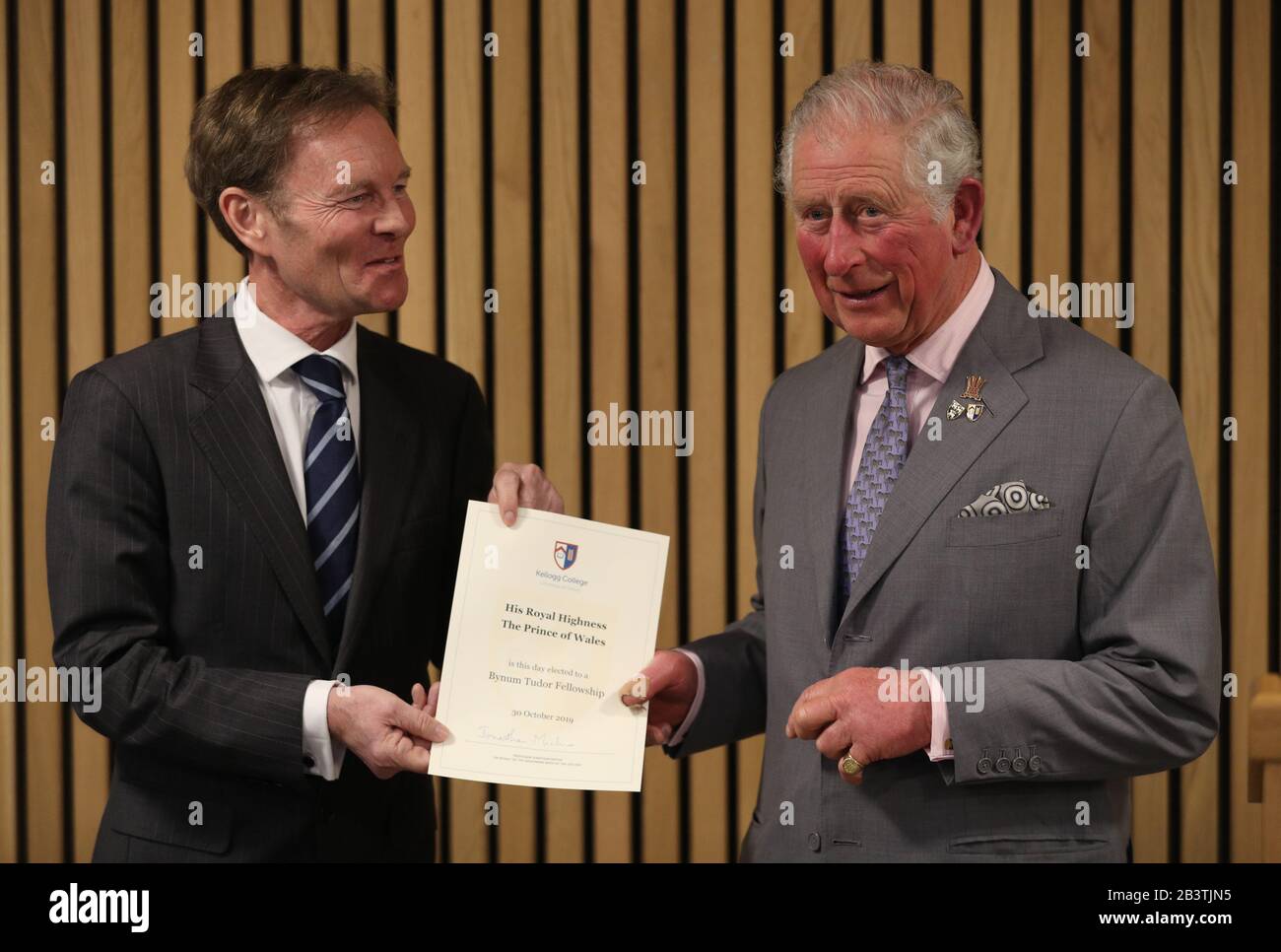 The Prince of Wales (left) is presented with a certificate after being ...