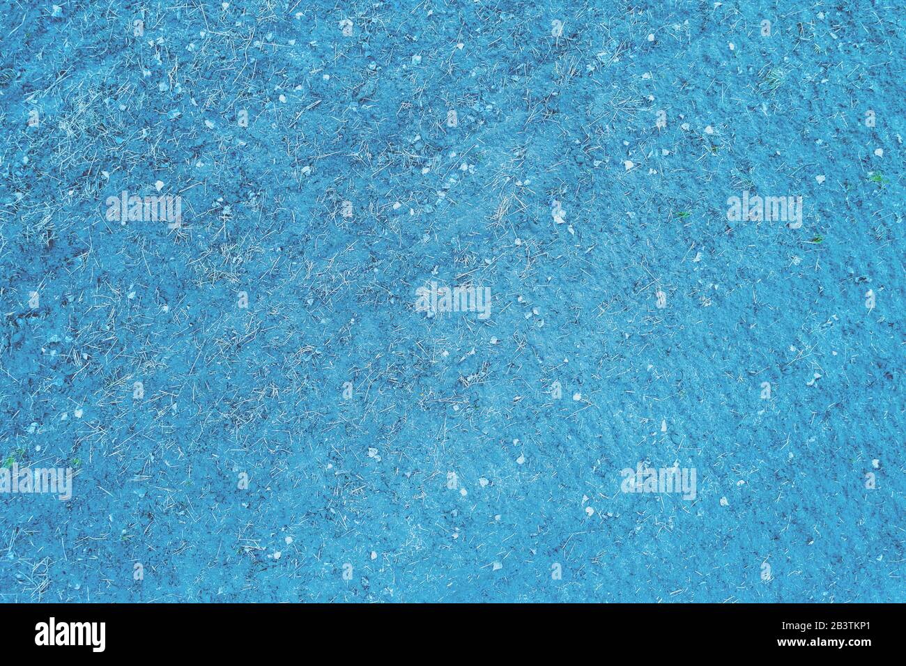 Soil texture background. Plowed field in early spring. Blue toned land ...