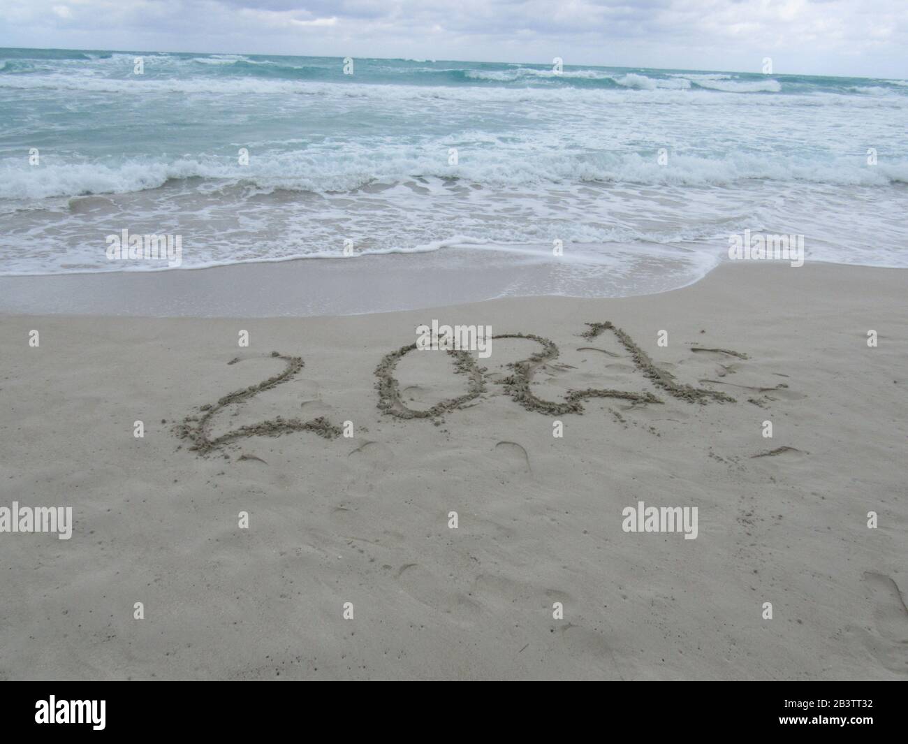 Happy New Year 2021, lettering on the beach with wave and clear blue ...