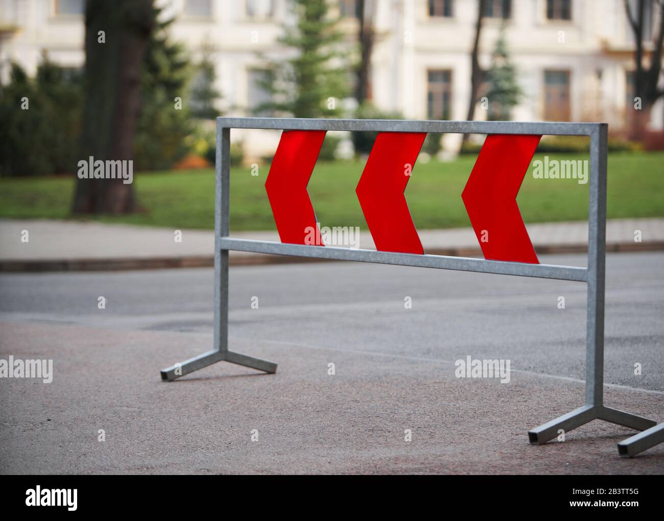 asphalt road with arrow fluorescent light signs and city background ...