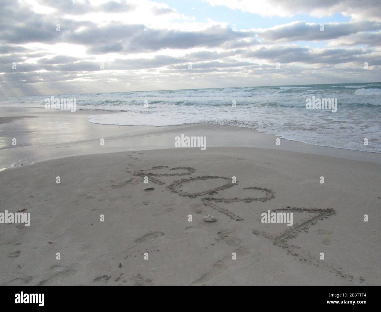 Happy New Year 2021, lettering on the beach with wave and clear blue ...