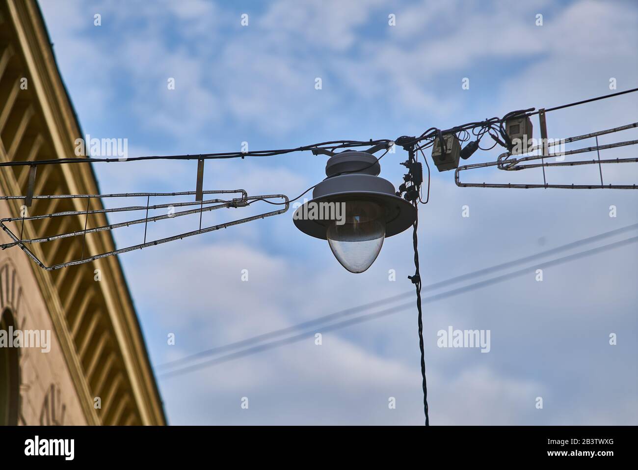 Urban view. Street lamps on aerial wires against cloudy blue sky Stock ...