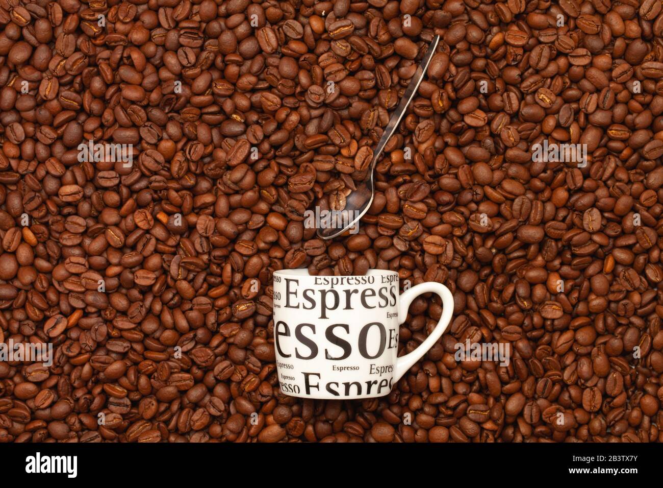 Cup of coffee on a table full of coffee beans. Coffee design Stock ...