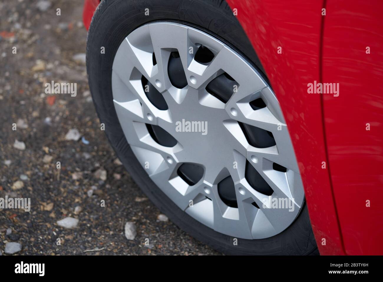 Cherry red car front detail with big light-alloy wheel Stock Photo - Alamy