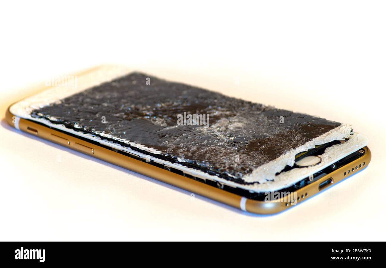Modern smartphone with highly broken screen isolated on white ...